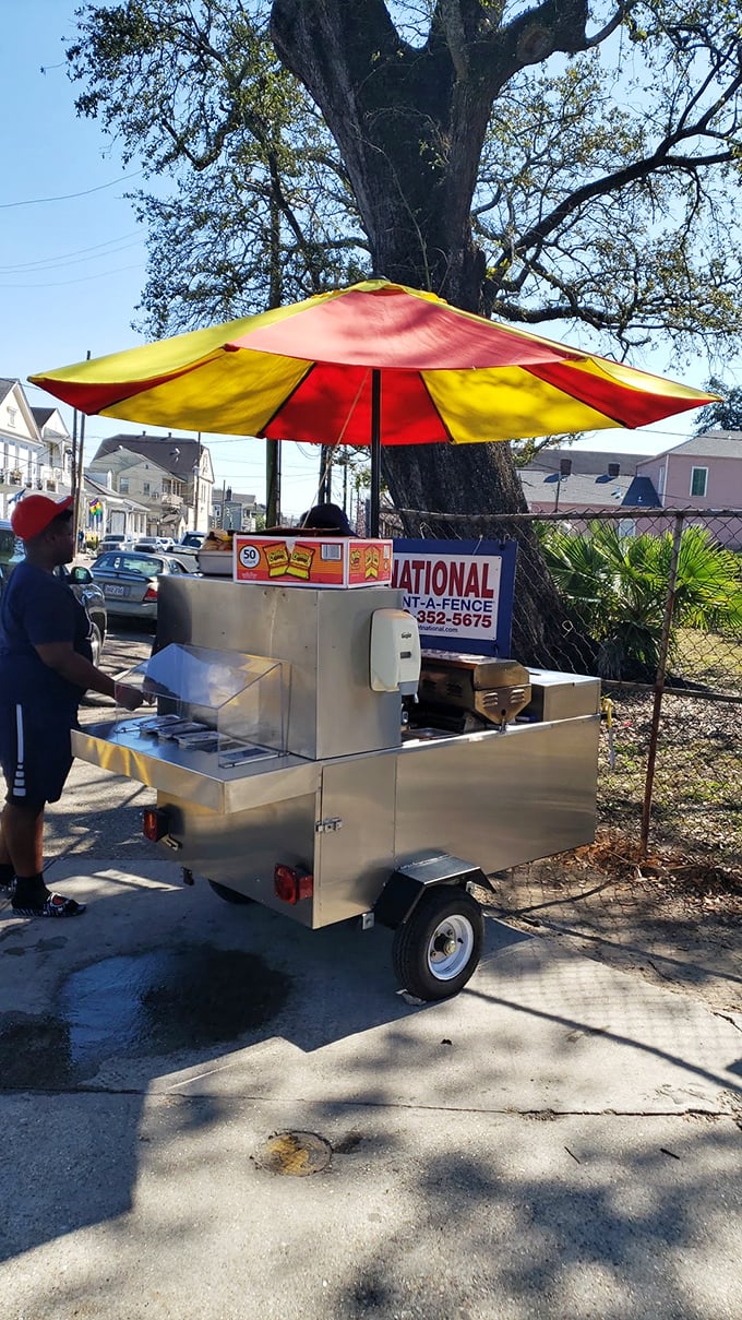 Street food perfection under a carnival-colored umbrella—simple, mobile, and utterly irresistible.