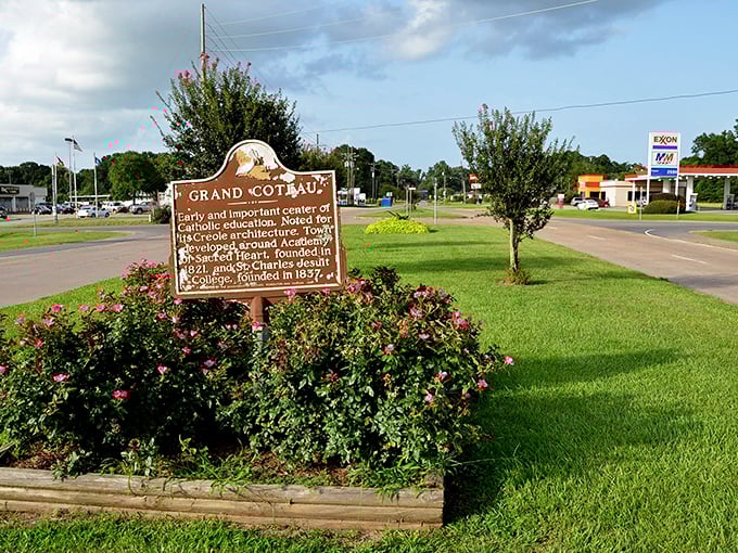 Grand Coteau's historic marker stands proudly among flowers, marking centuries of fascinating Louisiana heritage.