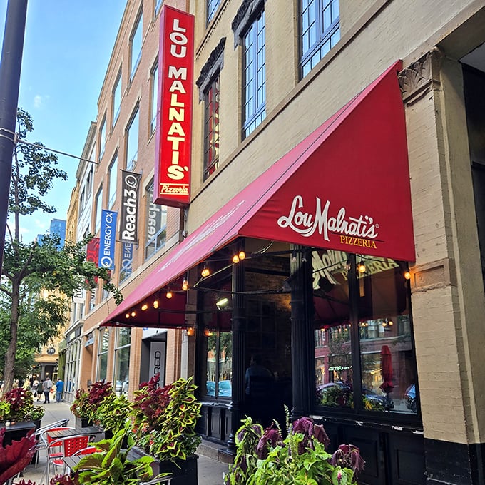 Lou Malnati's red awning signals pizza joy ahead, like the red carpet for your taste buds.