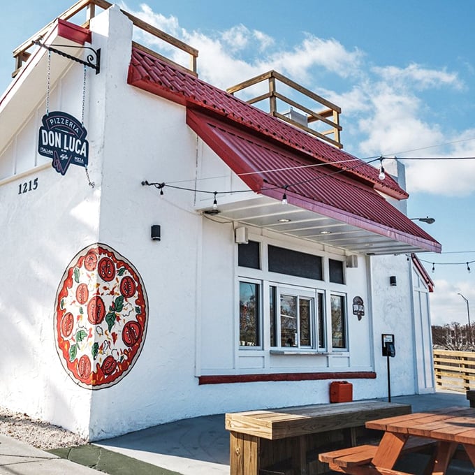 That giant pizza mural on Don Luca's white building isn't just art – it's a preview of coming attractions.