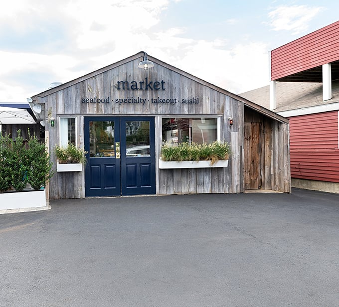 Weathered wood, navy blue doors, and the simple word "market"—sometimes the best seafood comes with the least fanfare.