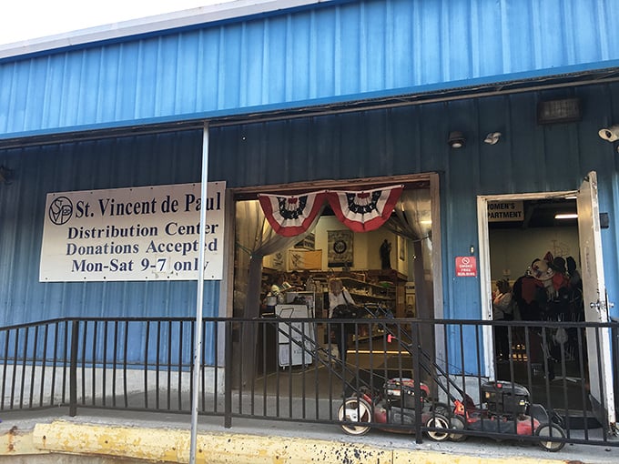 St. Vincent de Paul's bright blue building stands out like a sapphire in the Kentucky landscape. Those lawn mowers hint at the practical treasures waiting inside.