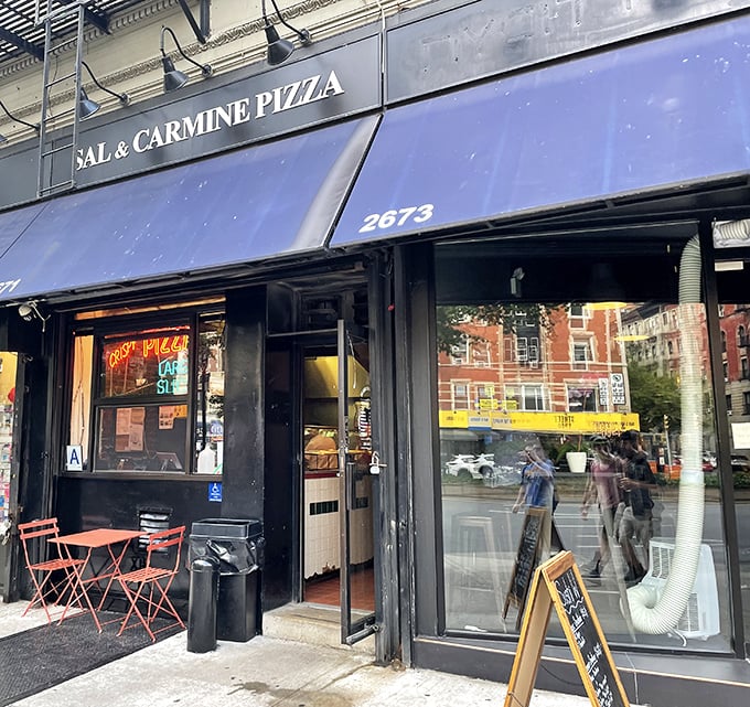 Sal & Carmine's blue awning beckons like a lighthouse for lost souls seeking perfect pizza.