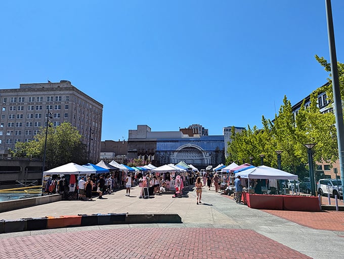Tacoma's urban marketplace transforms concrete into a vibrant shopping village under brilliant blue skies.