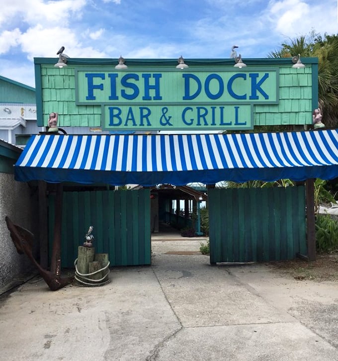 That turquoise-green facade with blue and white awning stripes screams "fresh seafood ahead!" like a beacon for hungry travelers.