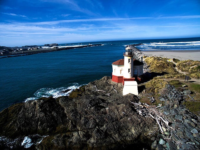 That little lighthouse stands guard like a faithful sentinel, rain or shine, looking postcard-perfect since day one.