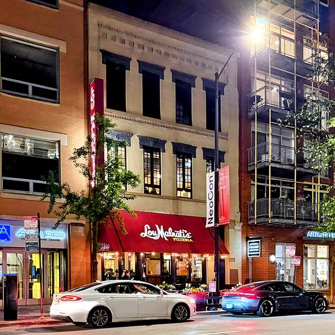 When night falls, Lou Malnati's glows with promise – a beacon of deep-dish delight in the urban landscape.
