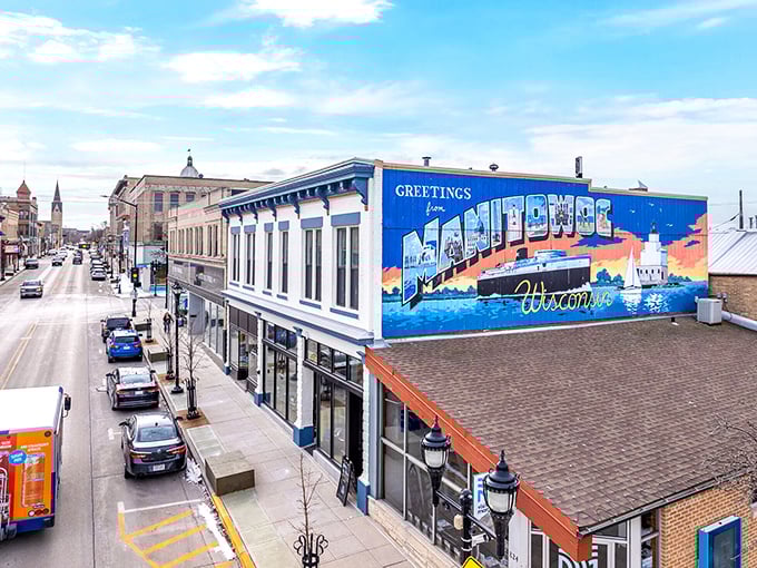 That "Greetings from Manitowoc" mural isn't just Instagram-worthy—it's the gateway to one of Wisconsin's most affordable retirement spots.