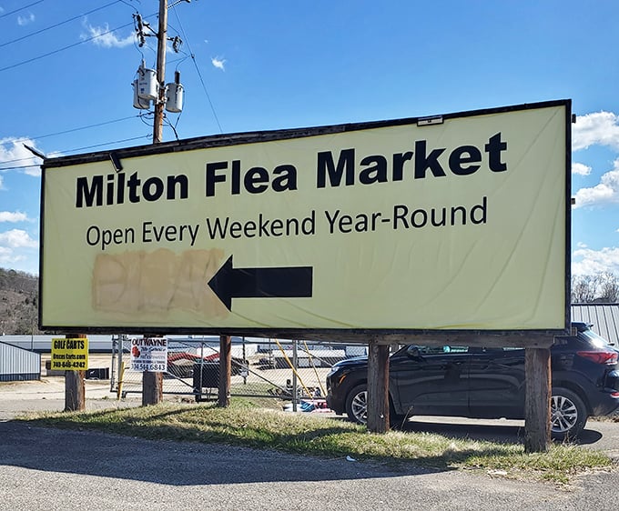 The Milton Flea Market sign points the way to weekend adventures—follow the arrow to bargain paradise!