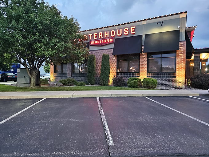 As evening falls, this brick facade glows with promise—seafood treasures await inside this suburban gem.