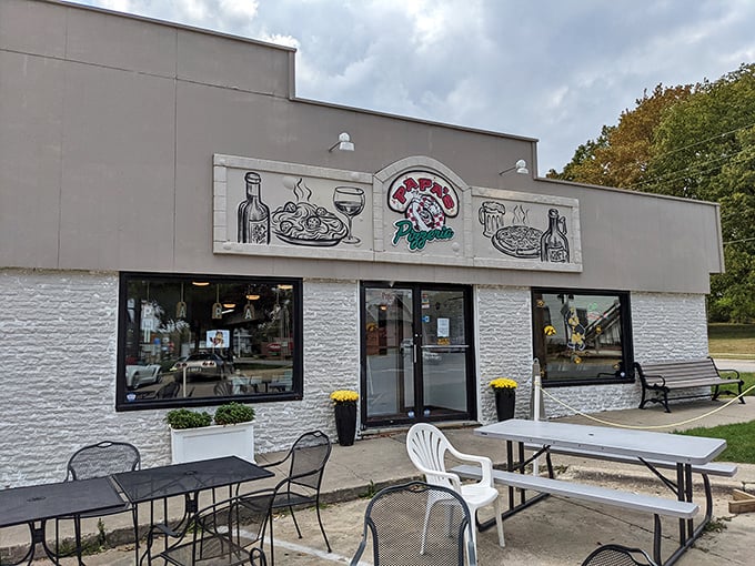 Simple white building, picnic tables outside – Papa's keeps it casual. But there's nothing casual about their dedication to great pizza.