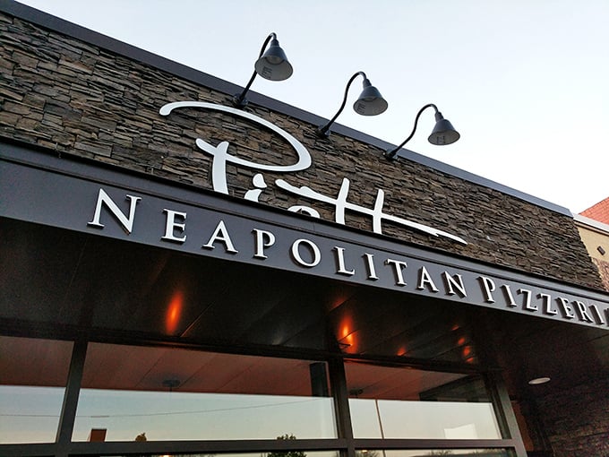 Evening at Piatto transforms this stone facade into a glowing temple of pizza perfection. Those three lamps stand guard over sacred dough.