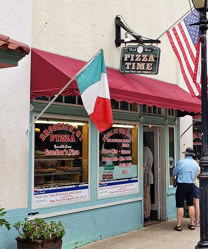 Italian and American flags proudly announce Pizza Time's heritage in St. Augustine. History never tasted so deliciously cheesy!