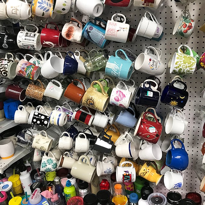 The mug wall—a ceramic autobiography of America's travels, corporate events, and coffee obsessions all hanging in suspended animation.