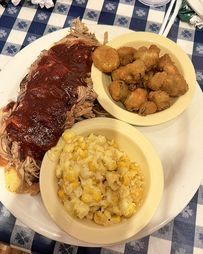 BBQ that doesn't need fancy presentation – just a plate big enough to hold all that smoky, saucy goodness alongside creamy corn pudding and crispy okra.