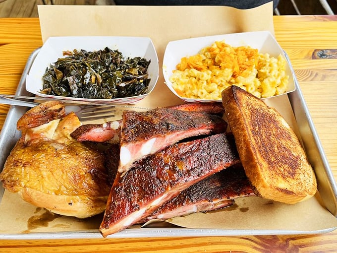 When ribs and chicken share a tray with mac and cheese and collards, it's not just a meal—it's a Southern symphony on a metal stage.