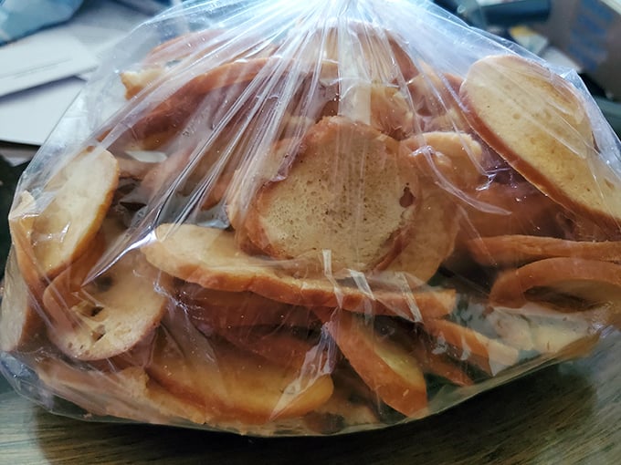A bag of homemade bagel chips—the unsung heroes of the deli world. Crispy, seasoned perfection that makes potato chips seem like a sad compromise.