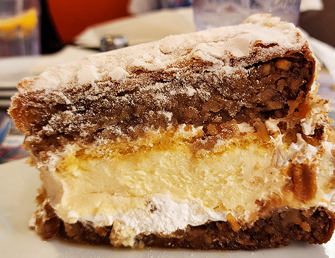 This isn't just dessert—it's architecture. Layers of flaky pastry, creamy filling, and nuts create a sweet skyscraper worth every calorie.