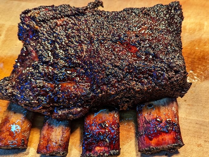 These beef ribs aren't just dinner—they're prehistoric monuments to carnivorous joy. Fred Flintstone would weep with happiness at the sight.