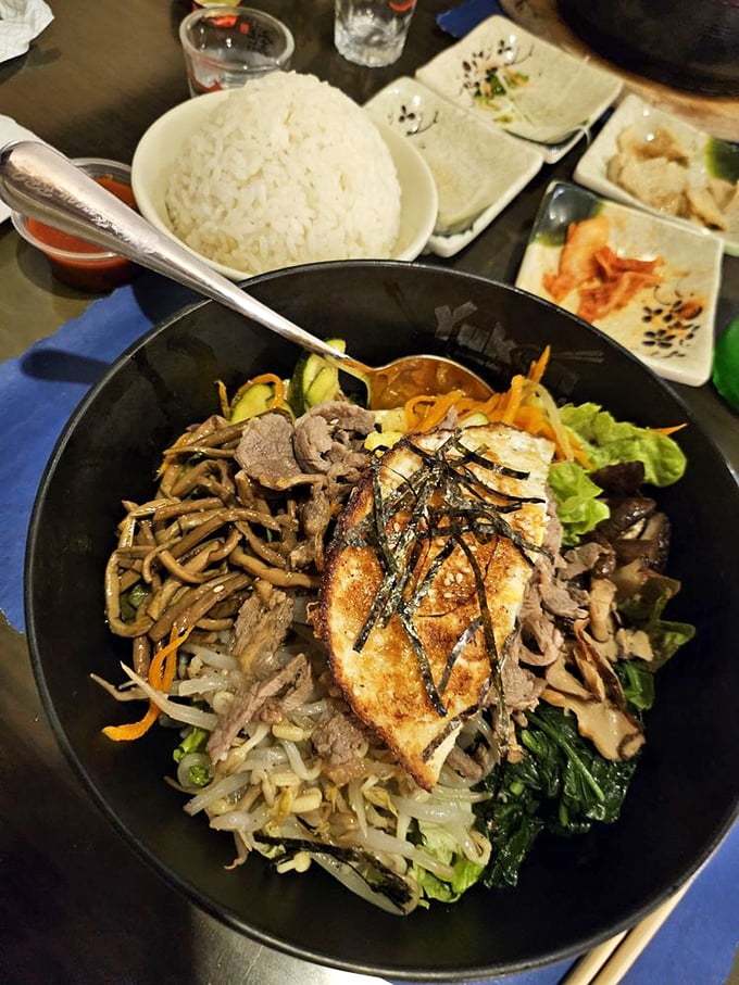 Bibimbap – a colorful Korean masterpiece where the egg on top is like the cherry on a sundae, except it's savory and you mix it all together.