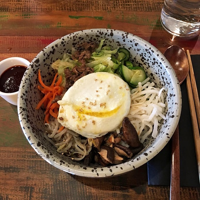 Bibimbap arrives like edible art – mix it up and watch the magic happen in your bowl.