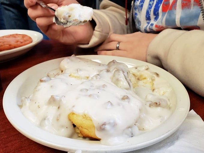 Someone's lifting a forkful of what might be the South's greatest contribution to civilization—biscuits swimming in creamy, pepper-speckled gravy.