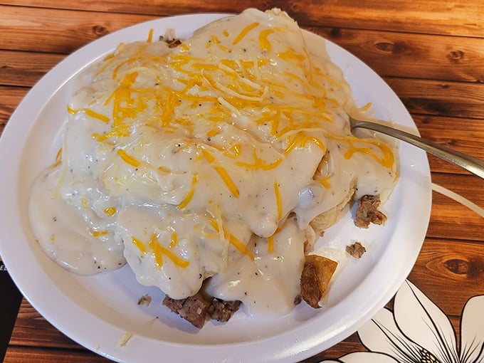 These biscuits and gravy aren't just a meal, they're an Alabama institution. That melted cheese on top? That's what we call Southern innovation.