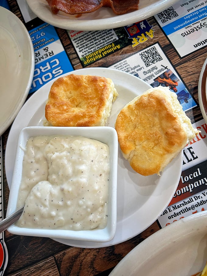 Fluffy biscuits drowning in peppery sausage gravy—the Southern comfort food equivalent of a warm hug from your favorite aunt.