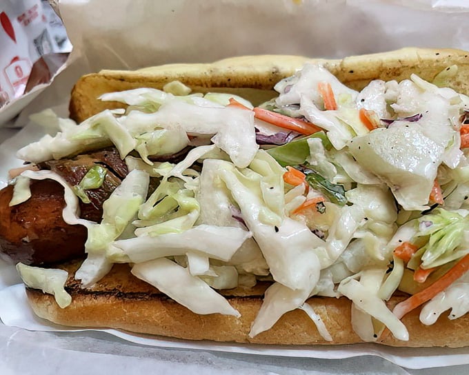 The "Blaze" hot dog lives up to its fiery name with a mountain of fresh slaw providing cool relief from the heat—a delicious balancing act.