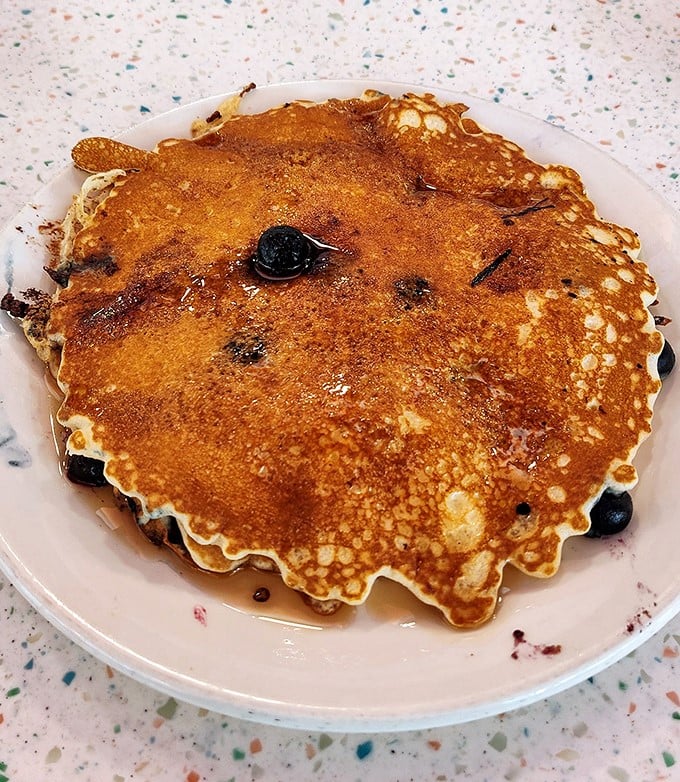 These blueberry pancakes don't just have berries—they've formed a delicious alliance. That golden-brown surface is the stuff of breakfast dreams.
