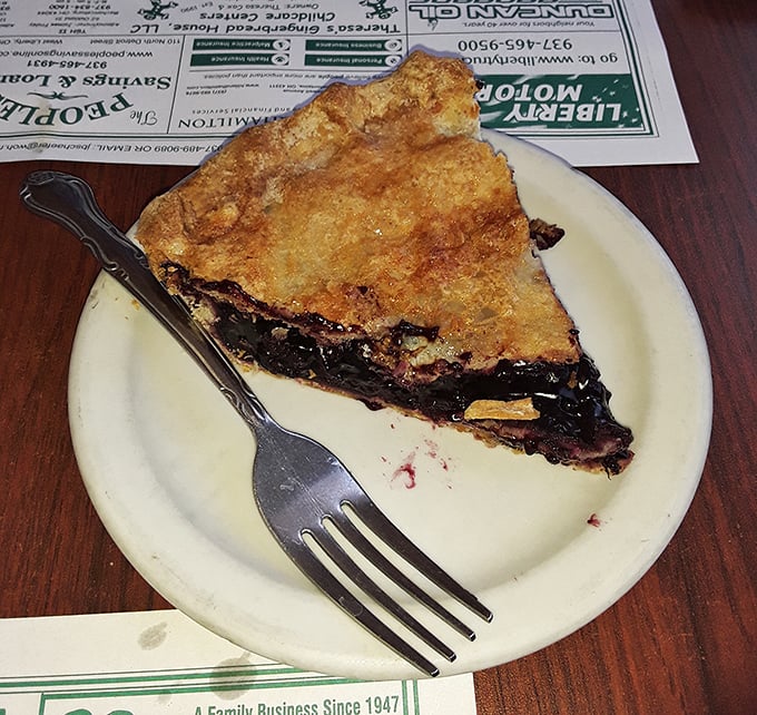 This isn't just blueberry pie—it's summer captured in a perfect golden crust. The fork marks tell you someone couldn't even wait for a photo.