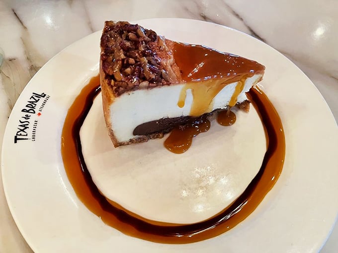 Not your average cheesecake—this Brazilian version sits on a chocolate base with caramel drizzle that would make even non-dessert people reconsider.