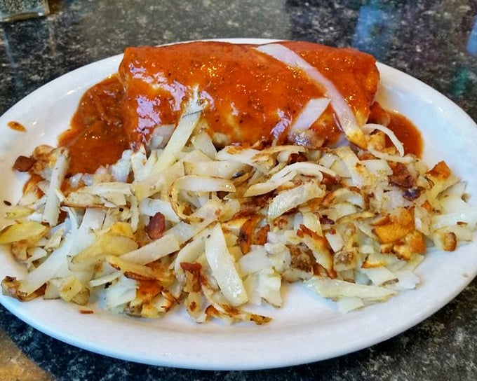 A breakfast burrito smothered in red sauce that's doing what all food should: making you forget your problems for at least one delicious meal.