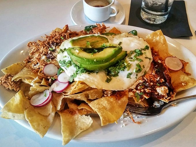 Breakfast nachos that blur the line between morning and fiesta – topped with an egg that says, "Yes, this is absolutely breakfast."