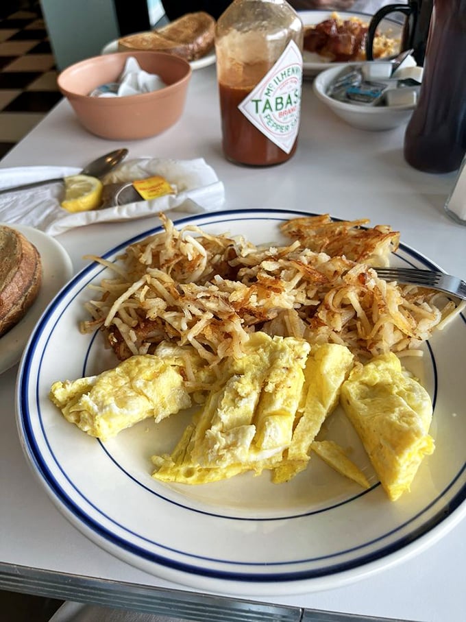 Breakfast perfection doesn't need filters – just perfectly scrambled eggs alongside hash browns crisped to that magical golden-brown sweet spot.