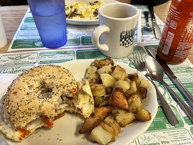 The breakfast sandwich and home fries combo that's launched a thousand productive days. That coffee mug says it all—this is George's territory.