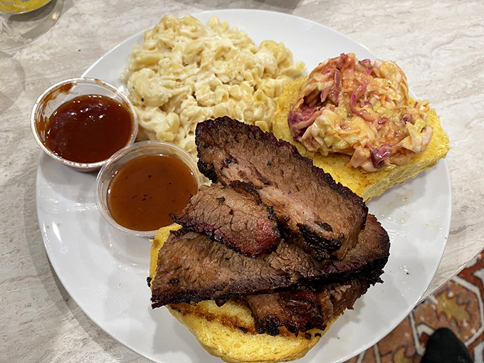 Brisket served with cornbread and sides – a plate that makes you want to cancel your afternoon plans and surrender to meat-induced bliss.