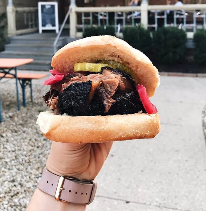 A brisket sandwich accessorized with pickles and onions – like a little black dress that's been perfectly accessorized for the meat prom.
