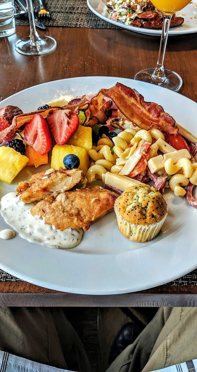 This brunch platter is what breakfast dreams are made of—where fried walleye mingles with fresh fruit and pasta salad like the most delicious morning party.