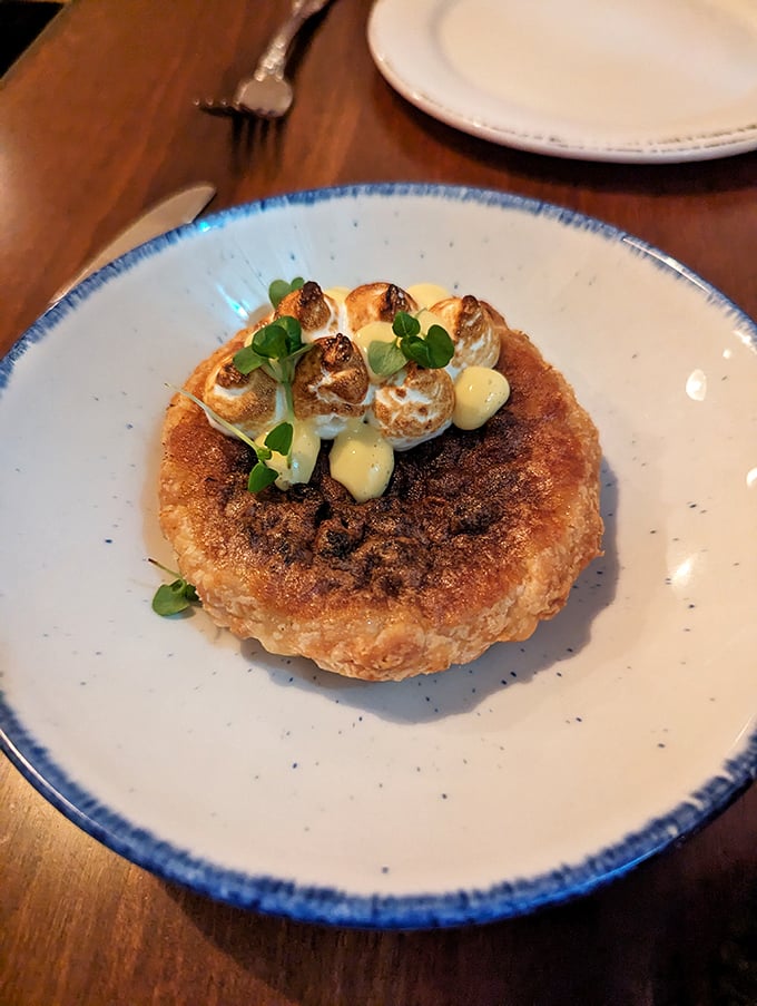 A butter tart crowned with toasted meringue that looks almost too pretty to eat—almost being the key word here, folks.
