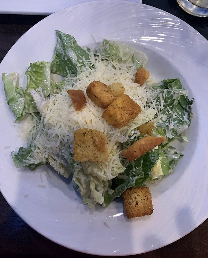 Caesar salad with generous parmesan and golden croutons—because even carnivores need their greens before the main event.