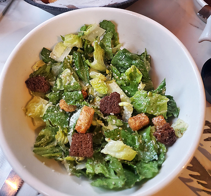 A Caesar salad that Julius himself would approve—crisp romaine, proper dressing with anchovy backbone, and croutons that crunch like autumn leaves.