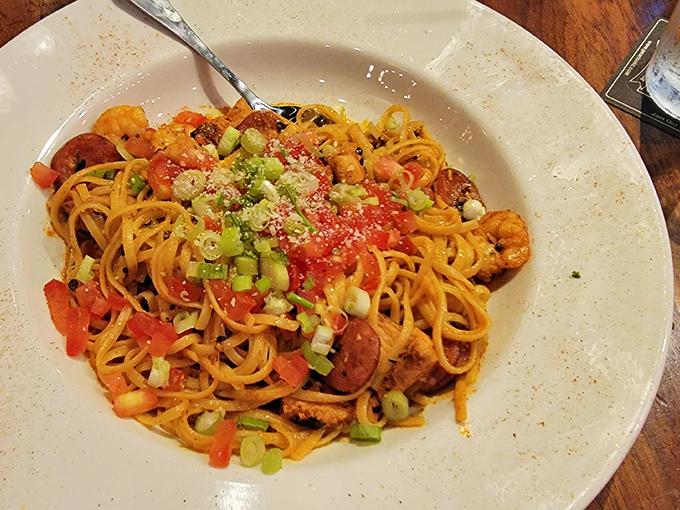 Pasta that's having an identity crisis in the best possible way—part Cajun, part Italian, and entirely delicious. Those green onions add the perfect pop of color.