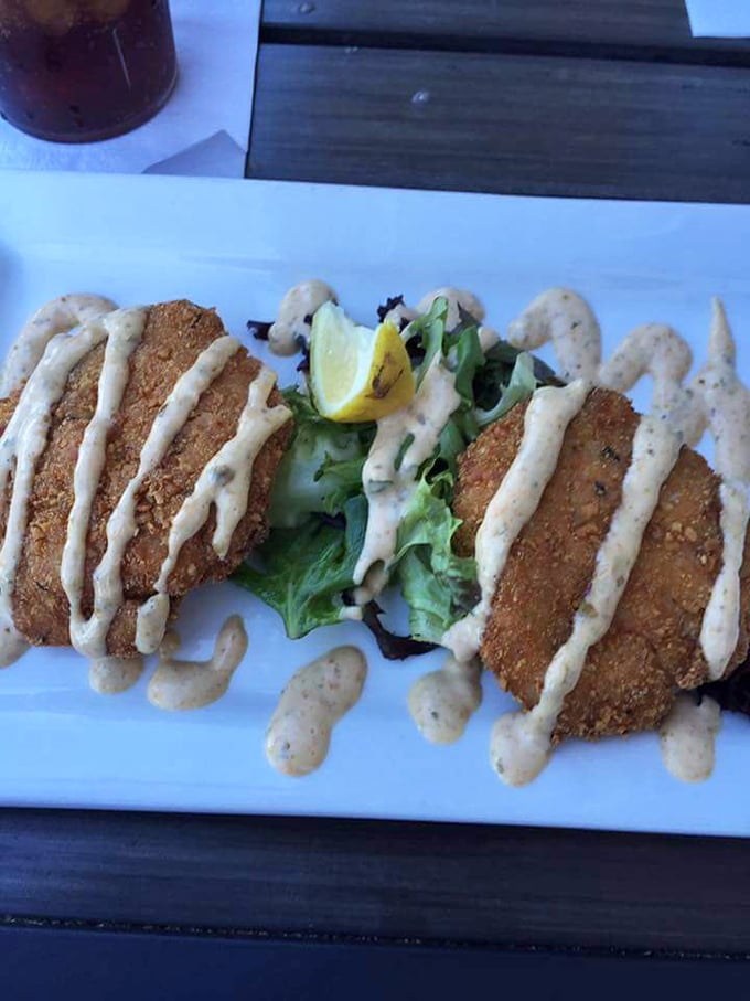 Those crab cakes aren't hiding behind excessive filler – just pure crabmeat with a golden crust and a drizzle of remoulade. Perfection.