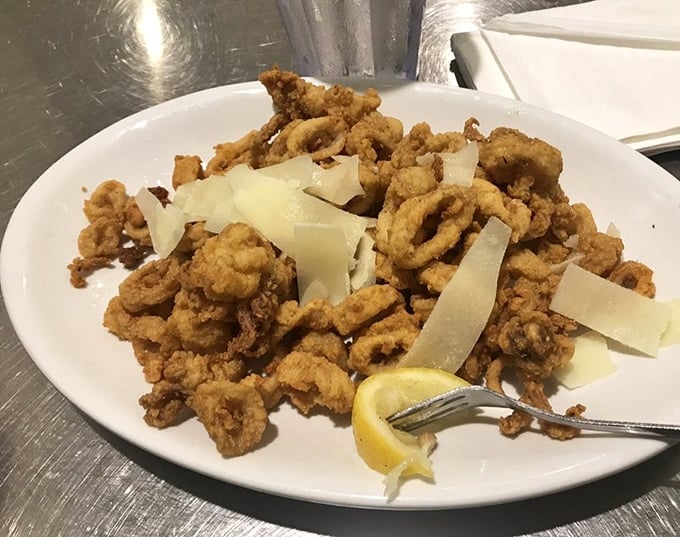 Crispy calamari with shaved parmesan—proof that sometimes the simplest preparations create the most memorable bites. The lemon wedge isn't optional, folks.