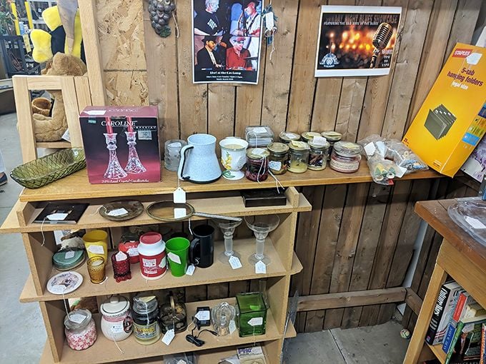 A wooden display showcases everything from crystal candlesticks to vintage jars. Each shelf tells a different story, waiting for new chapters to be written.