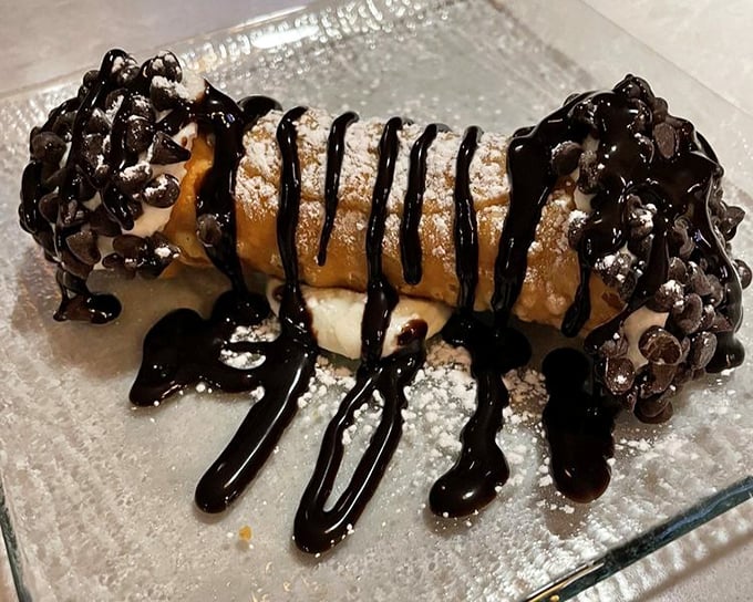 This cannoli isn't just dessert, it's therapy – chocolate-dipped ends and powdered sugar creating the ultimate stress-relief system.