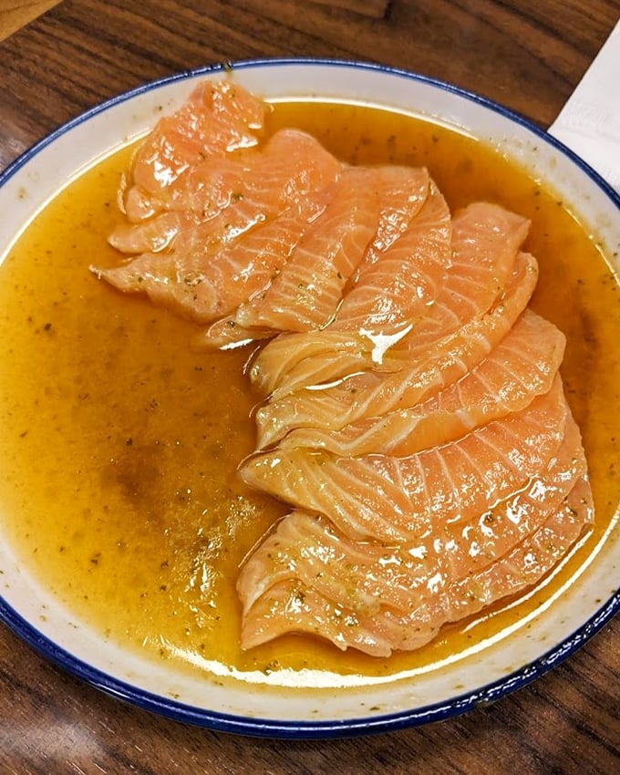 Carpaccio De Salmão swimming in citrusy ponzu sauce – proof that sometimes the best cooking involves no heat at all.