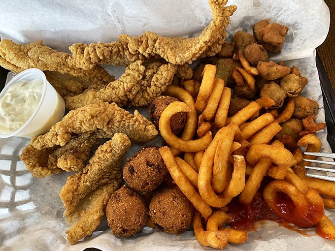 Golden-fried catfish, hush puppies, and curly fries—a Louisiana trifecta that proves sometimes the best things in life come from a deep fryer. 