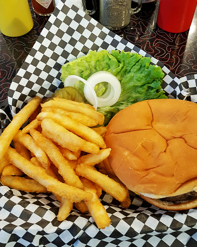 The classic American cheeseburger gets the respect it deserves here—served on a proper bun with crispy fries and zero pretension. Fast food chains, take notes.